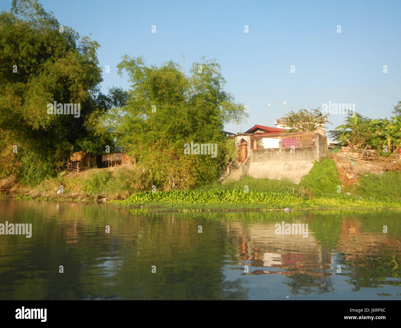 This image depicts the serene riverside districts in Calumpit, Bulacan ...