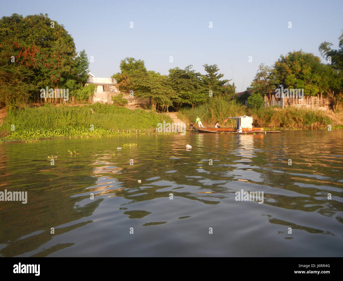 This image captures the serene riverside districts and villages along ...