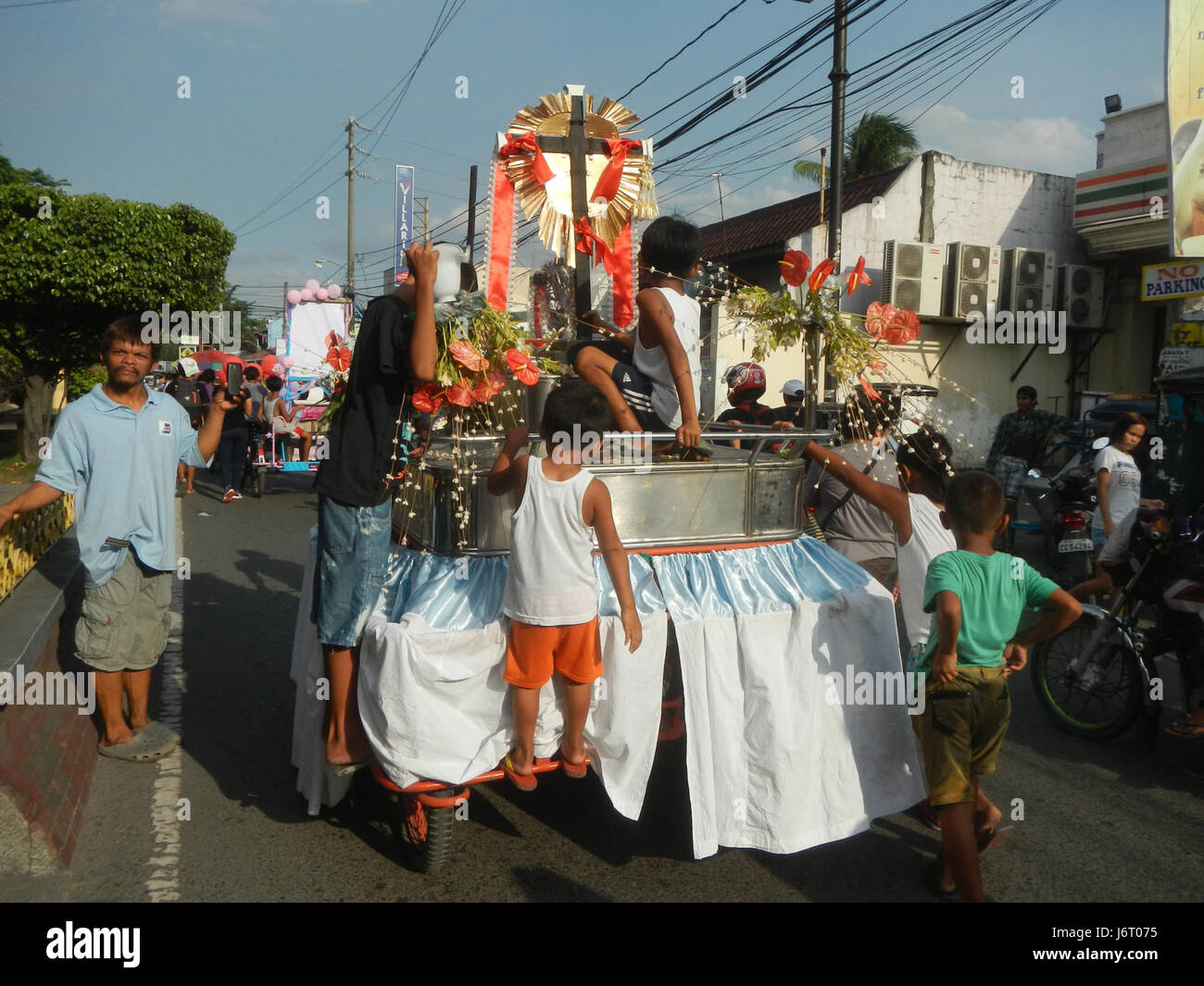 This image captures the Holy Cross Fiesta, a religious procession held ...