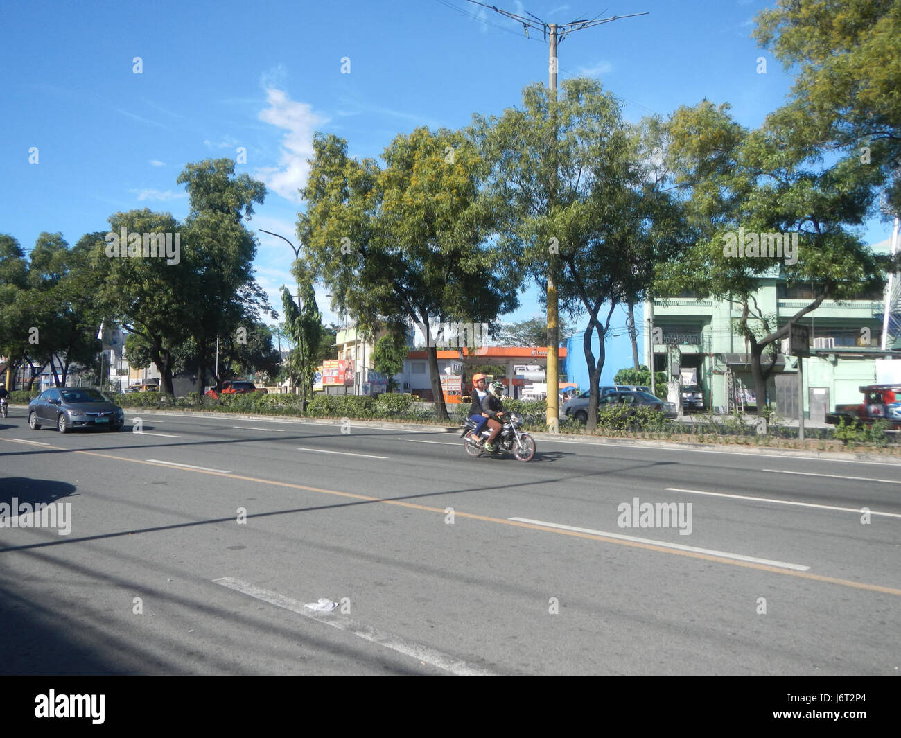 This photograph captures the SM City Marikina flyover and nearby ...