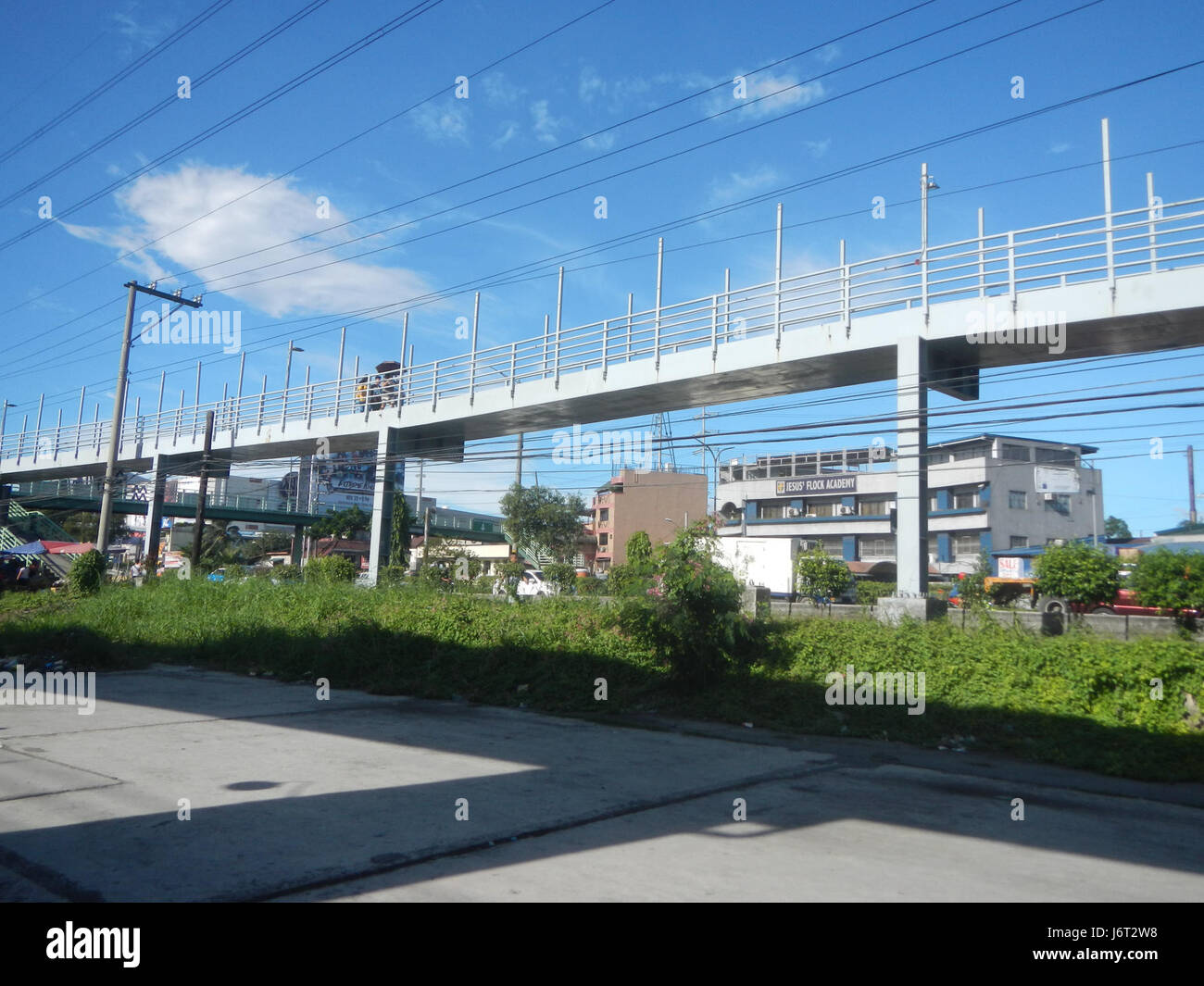 This title refers to a footbridge located along Marcos Highway ...