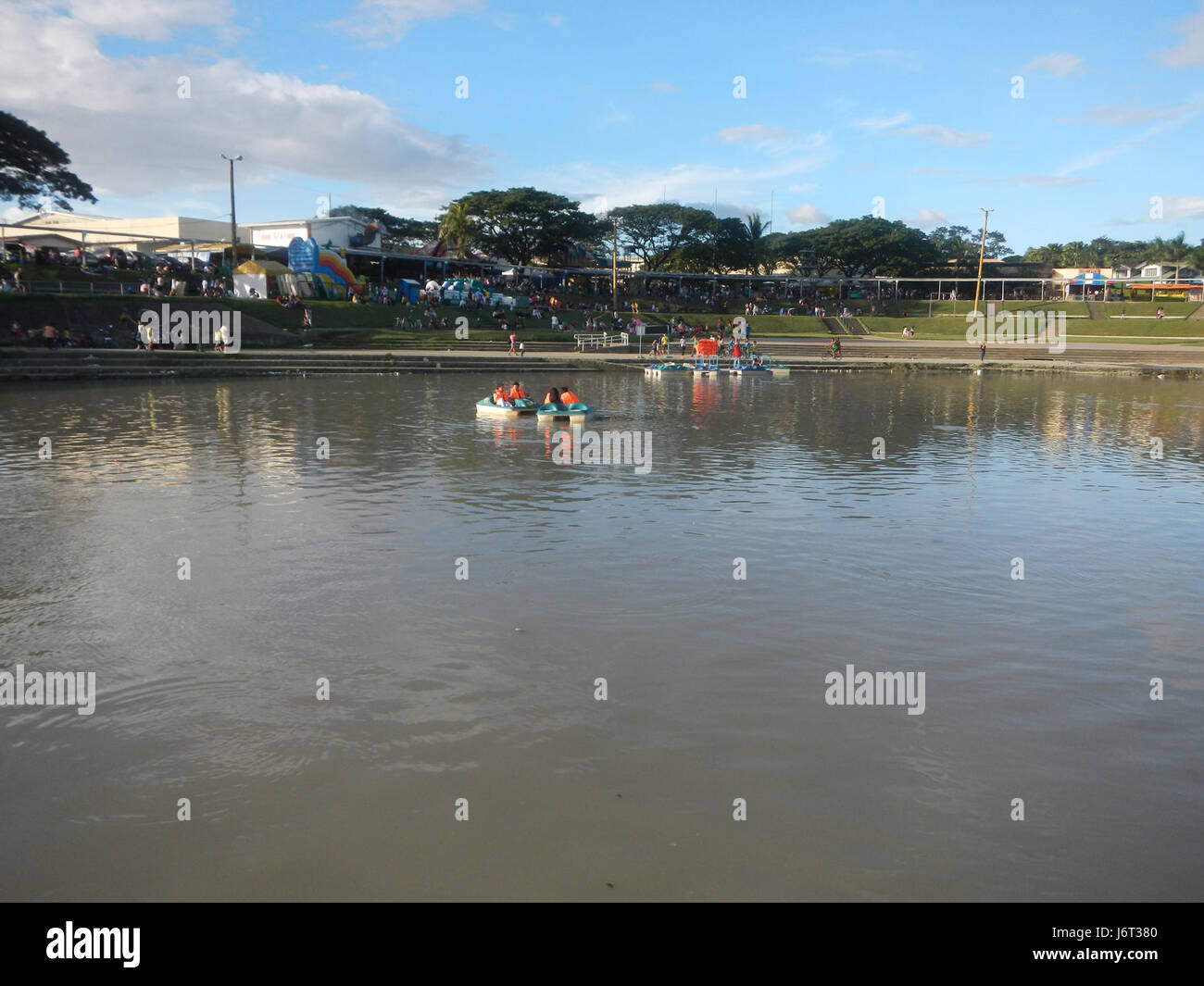 The image depicts the Marikina River Park, focusing on the banks at ...