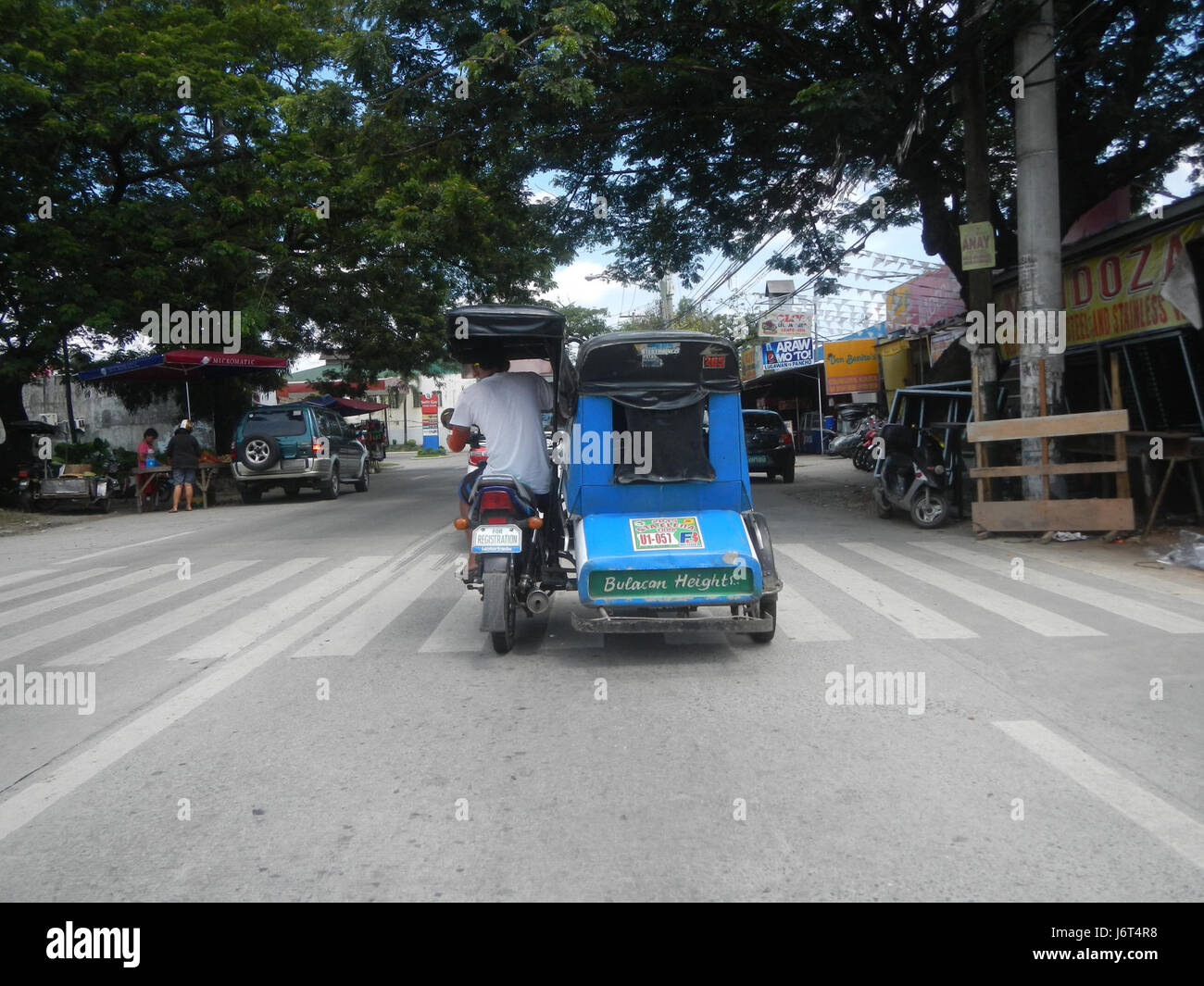 This image depicts a road in the Poblacion area of Bustos, Bulacan. The ...