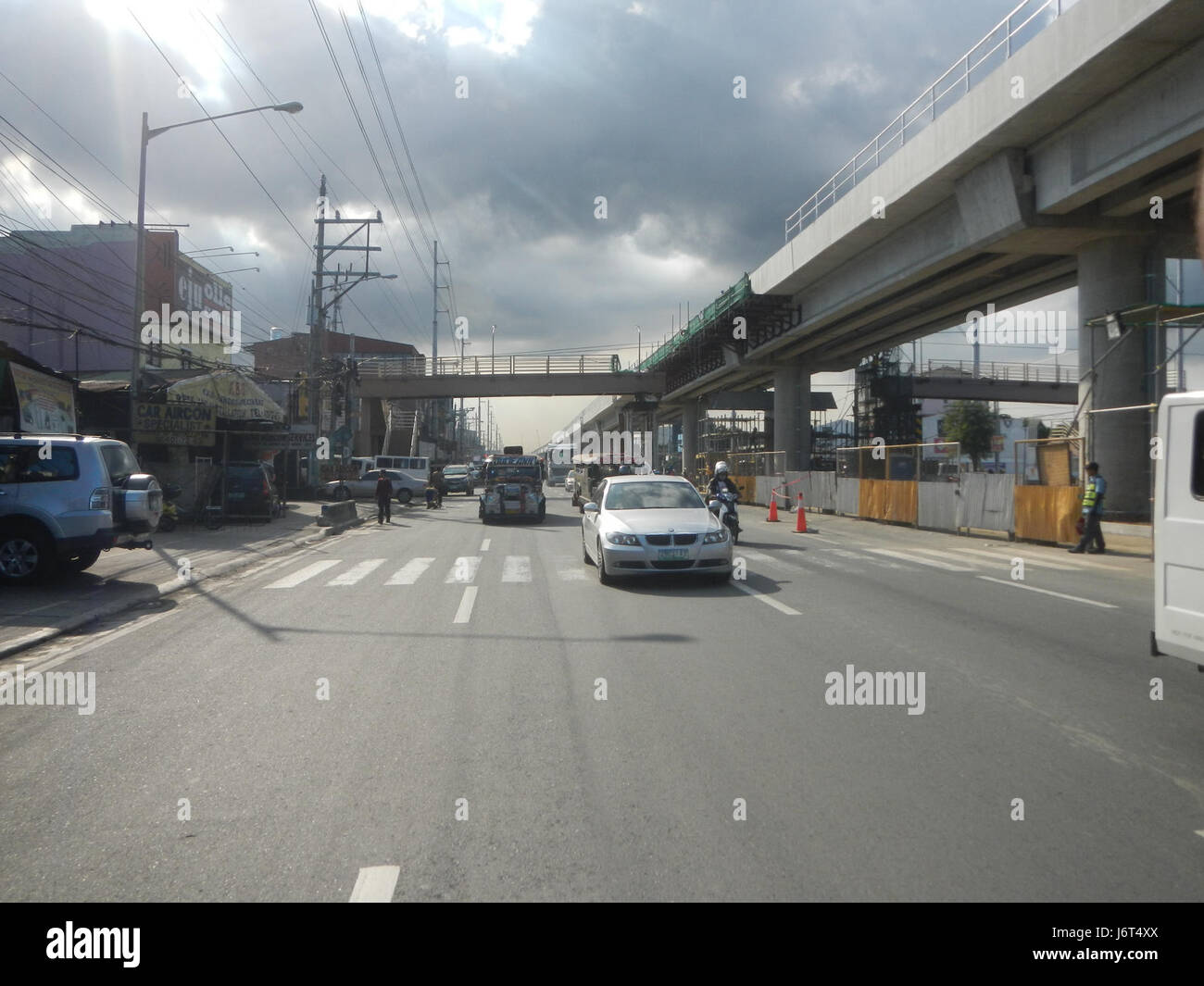 This image depicts a landscape along the Manila MRT Line 19, focusing ...