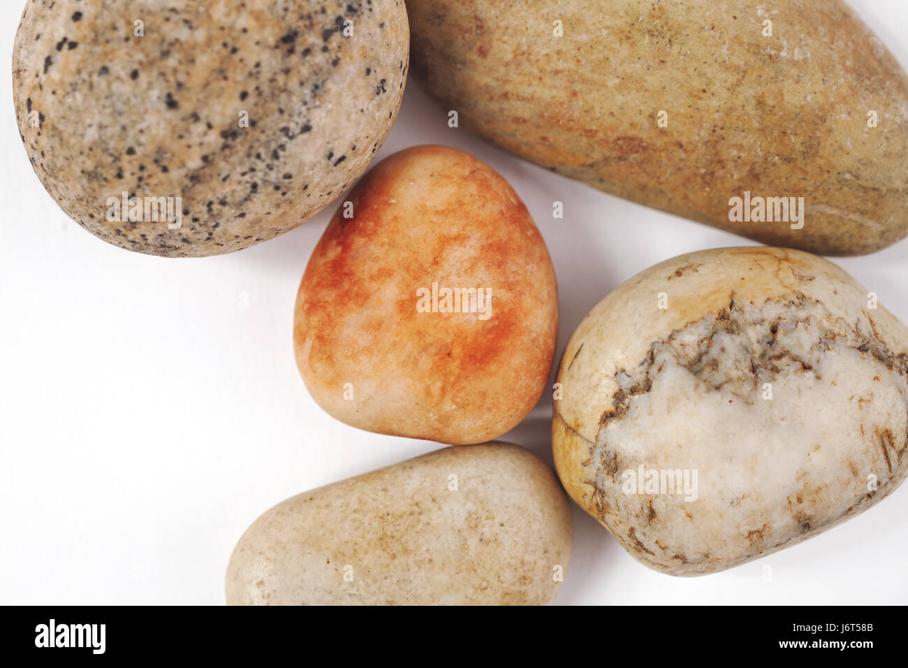 Five natural stones on a white background Stock Photo - Alamy