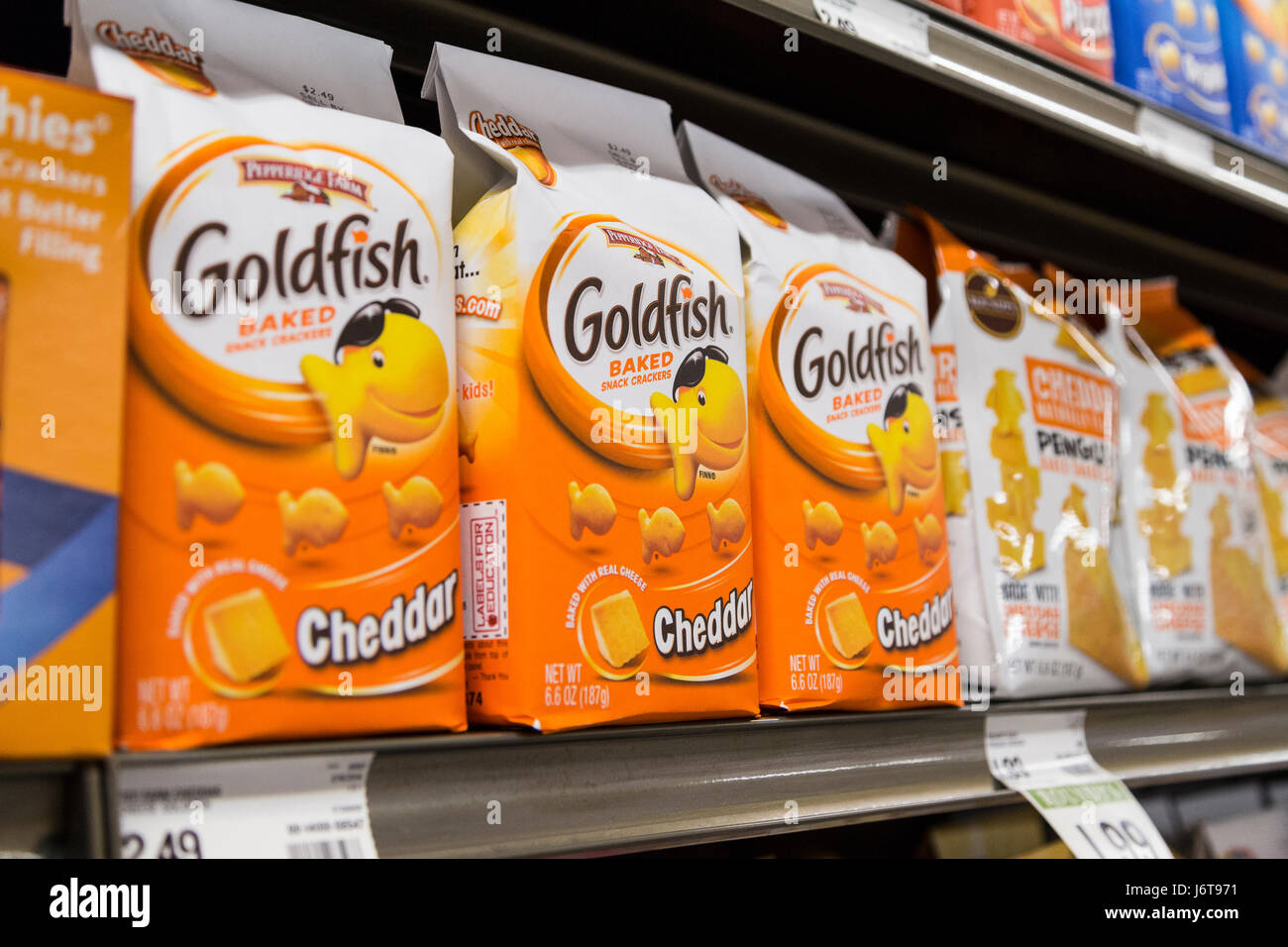 bags of Goldfish brand cheddar crackers on a shelf of a grocery store ...