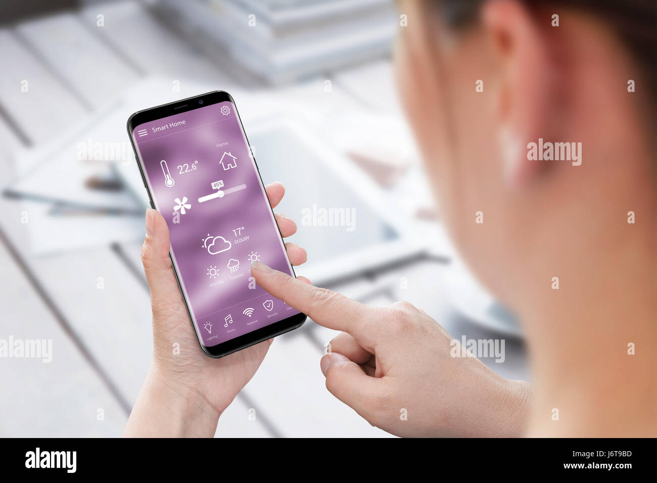 Woman use smart home control app on mobile phone Stock Photo - Alamy
