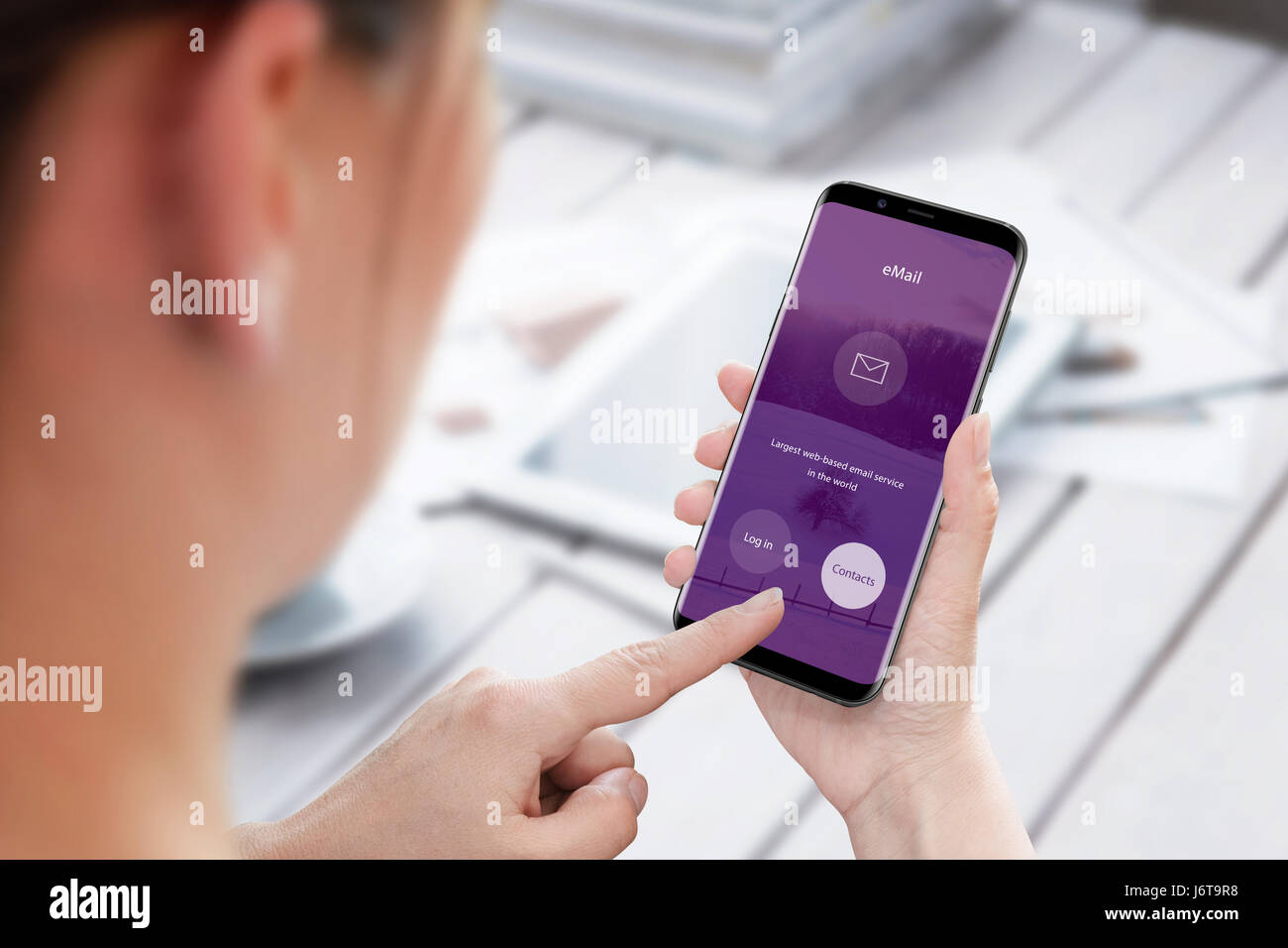 Sending email from mobile phone. Modern smart phone in woman hand. View ...