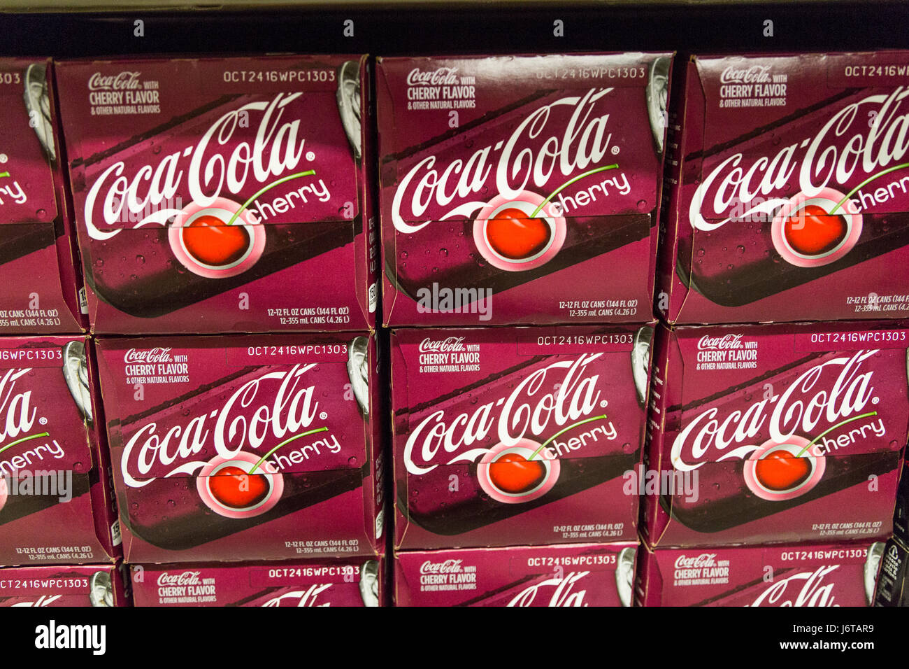 cases of Coca Cola soda on display on the shelves of a grocery store ...