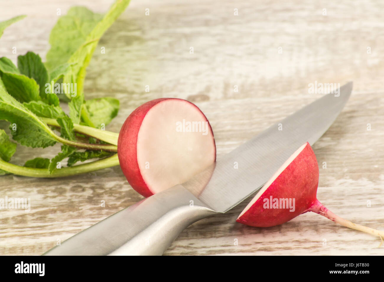 Juicy fresh radish in a cut on a white wooden background close up Stock ...