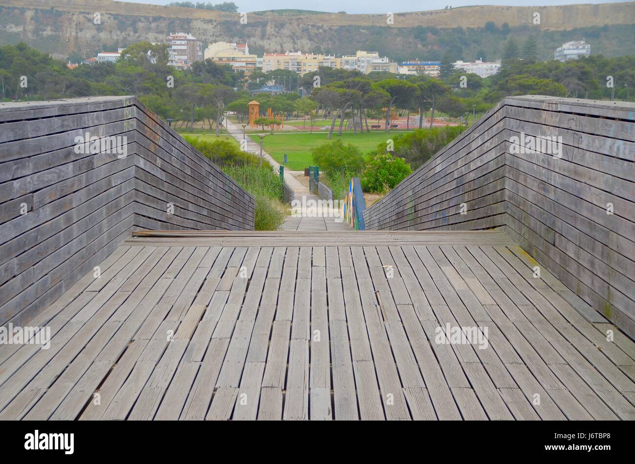 A small wood bridge does the transition between the beach and the park ...