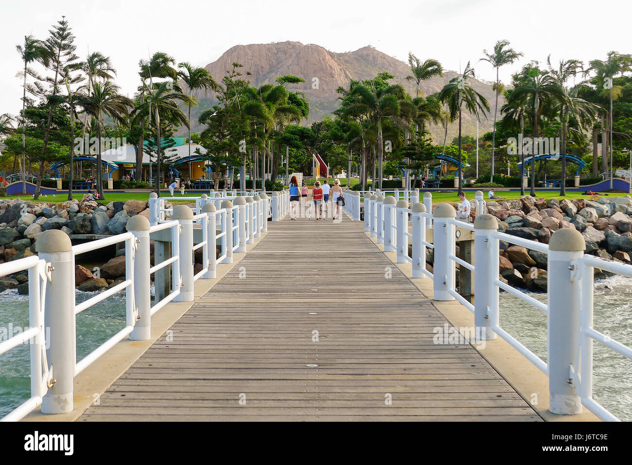 Families walking on the jetty on The Strand in Townsville, Australia ...