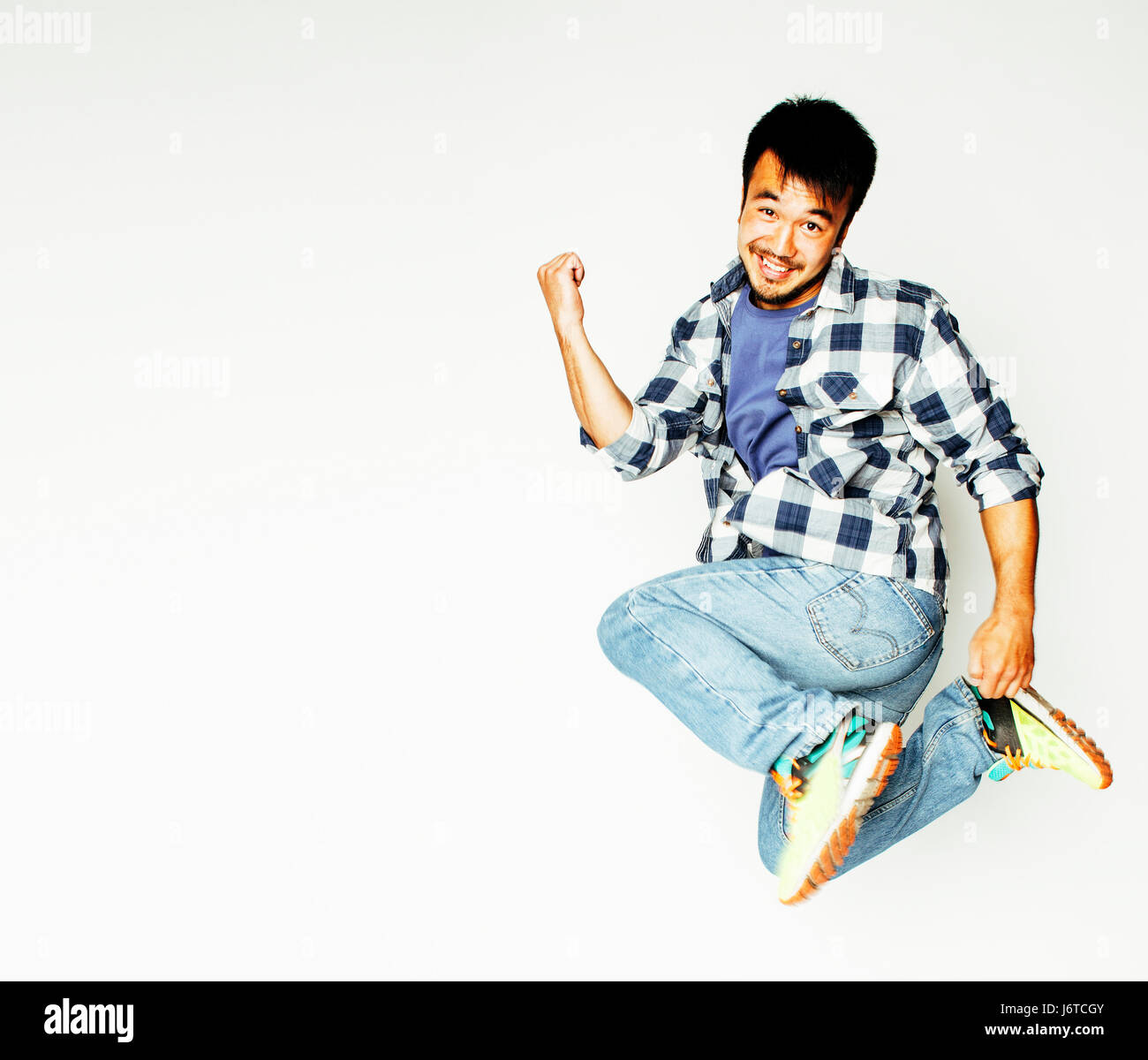 young pretty asian man jumping cheerful against white background Stock ...