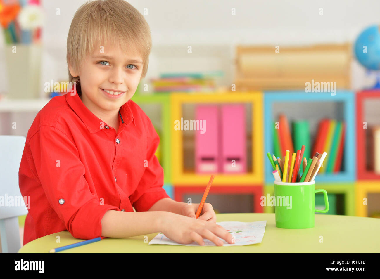 Cute boy drawing with pencils Stock Photo - Alamy