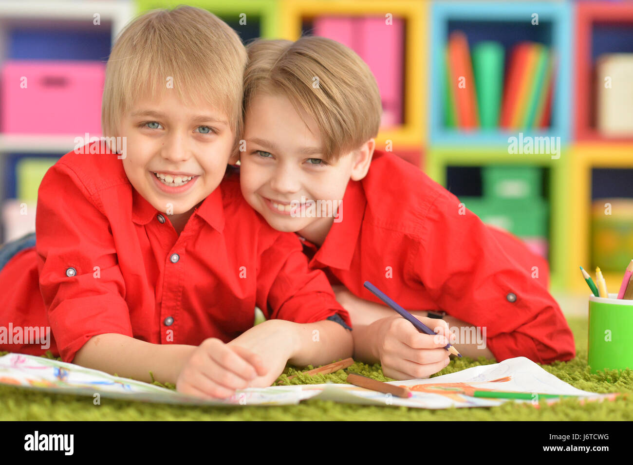 Two brothers draws with pencils Stock Photo - Alamy