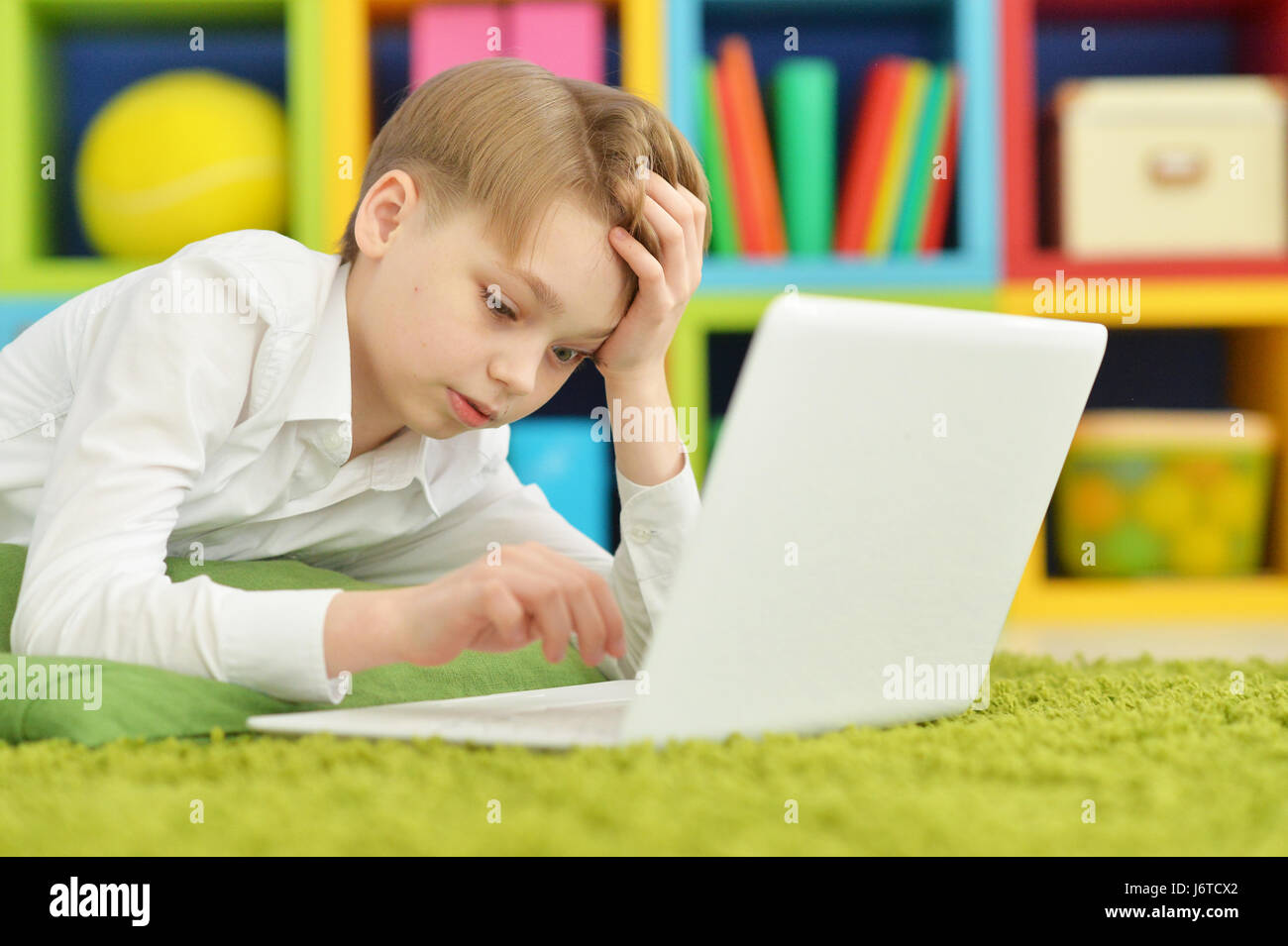 Cute boy with a laptop Stock Photo - Alamy