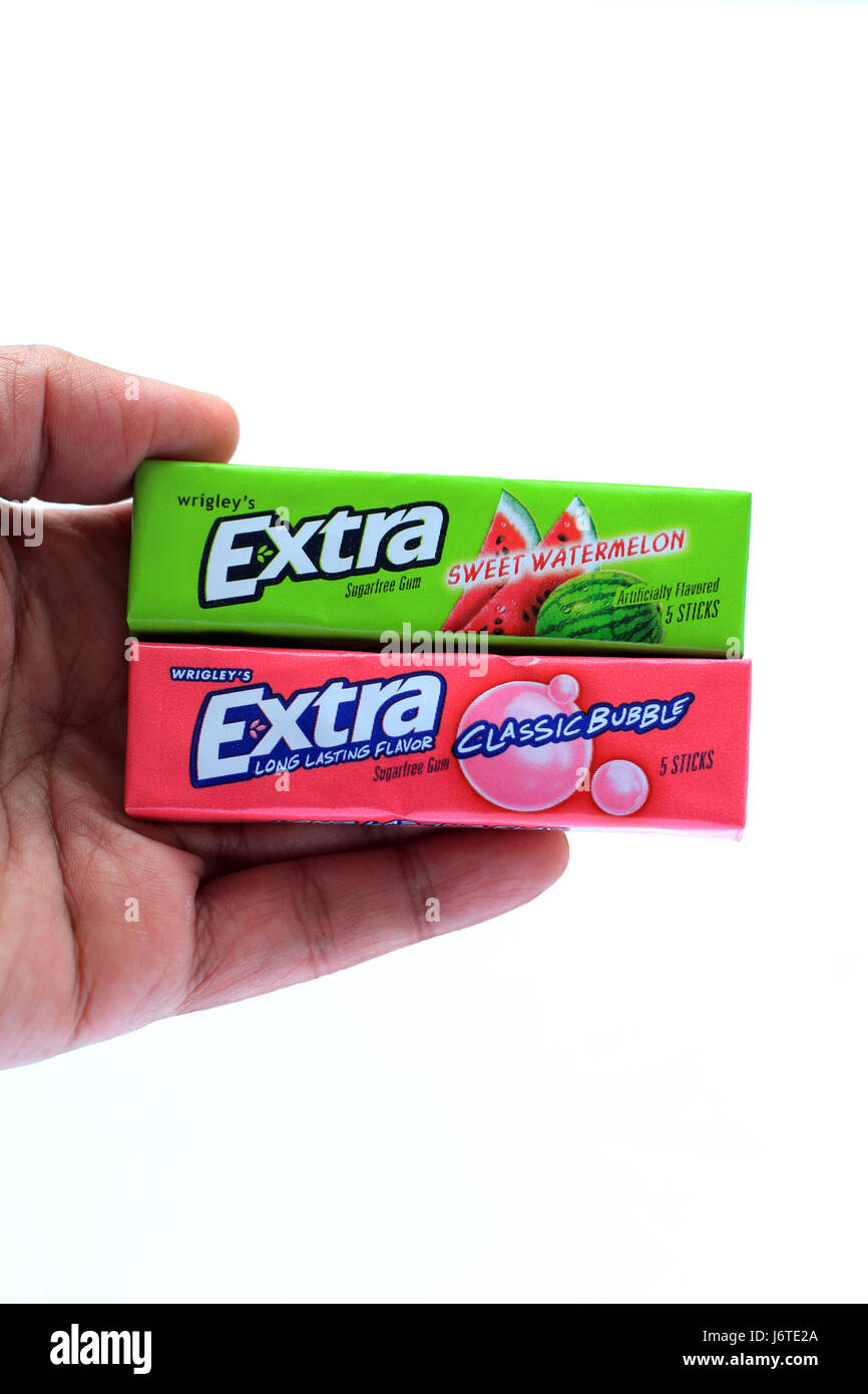 Hand holding Wrigley's Chewing Gum isolated against white background ...