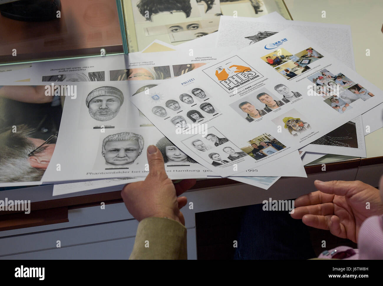 Print-outs of composite sketches on the desk of a composite sketch ...