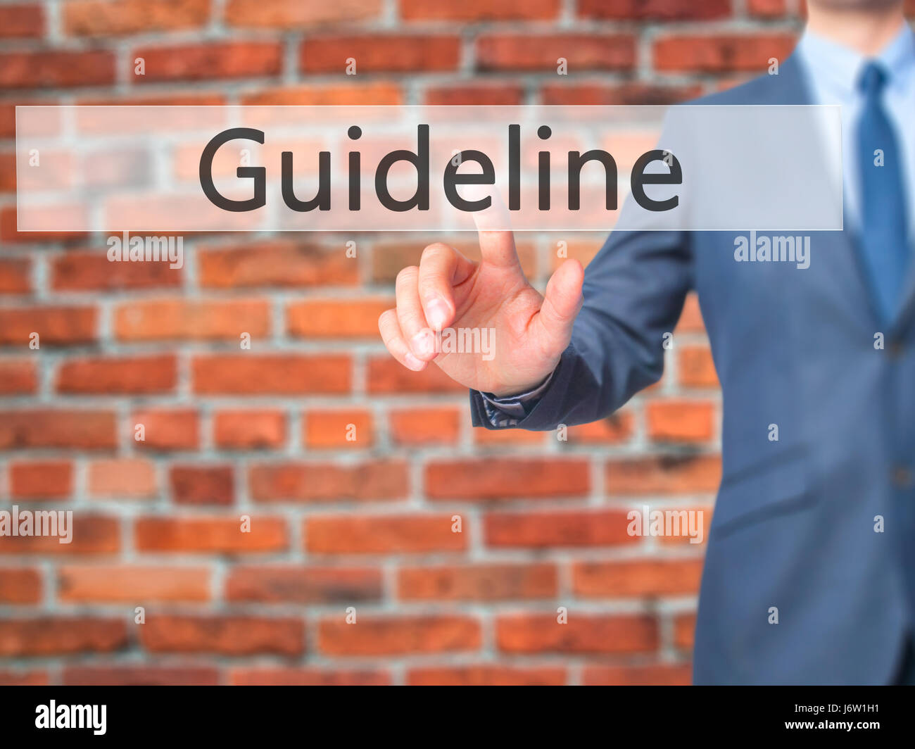 Guideline - Businessman hand pressing button on touch screen interface ...