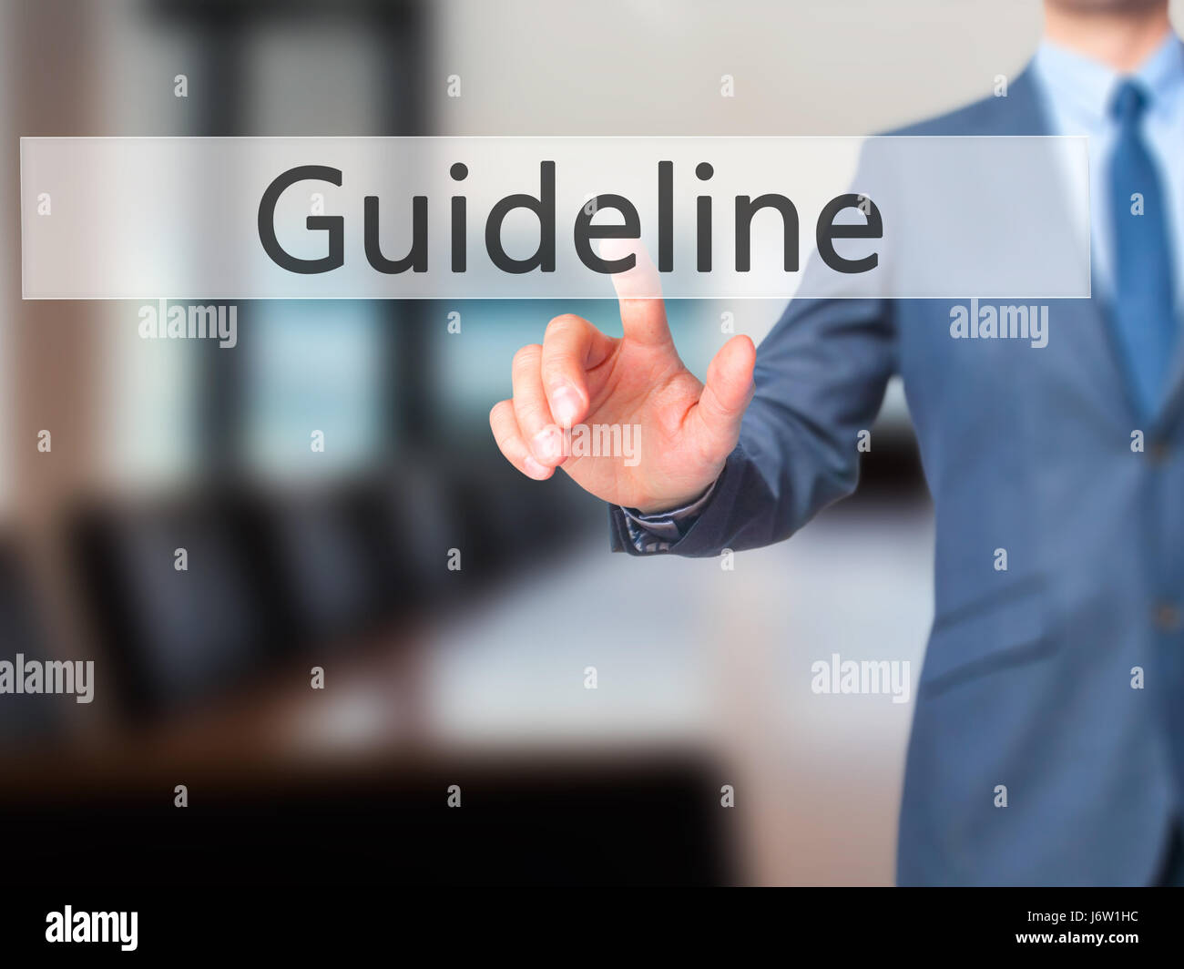 Guideline - Businessman hand pressing button on touch screen interface ...