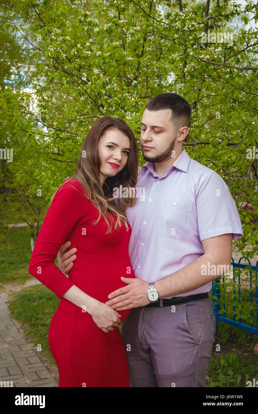 Happy young couple expecting baby in summer park Stock Photo - Alamy