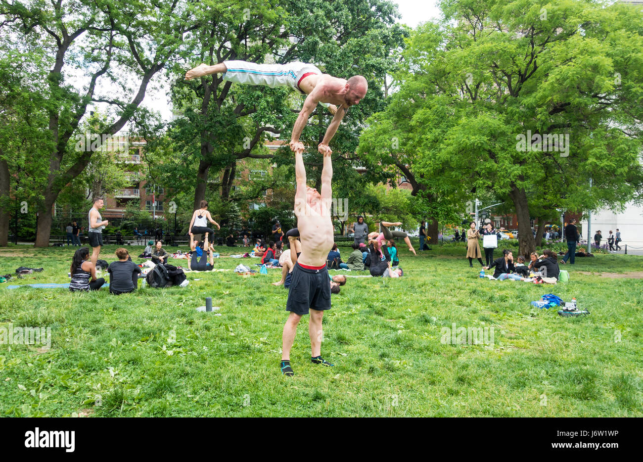 Gymnastics in Washington Square Park -- Two men preforming a hand ...