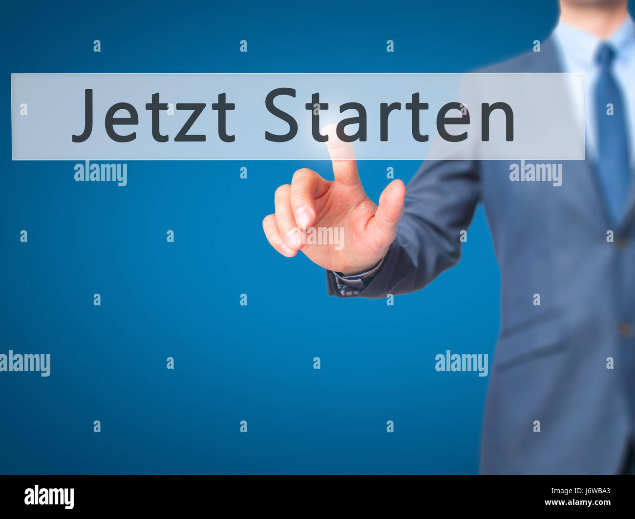 Jetzt Starten (Start Now in German) - Businessman hand pressing button ...