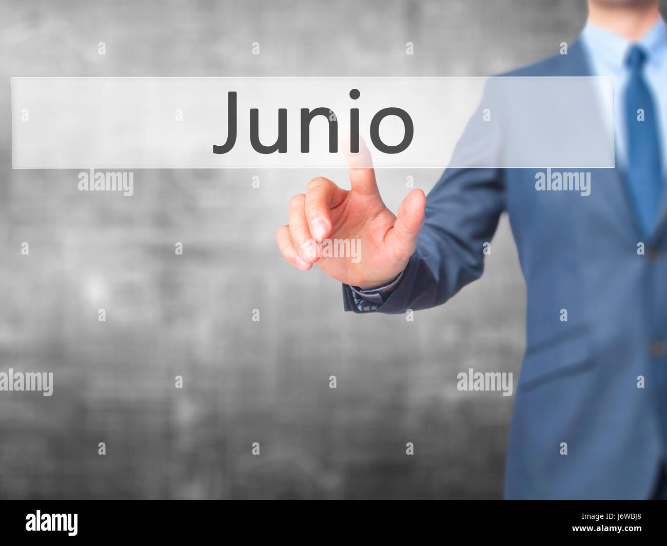 Junio (June in Spanish) - Businessman hand touch button on virtual ...