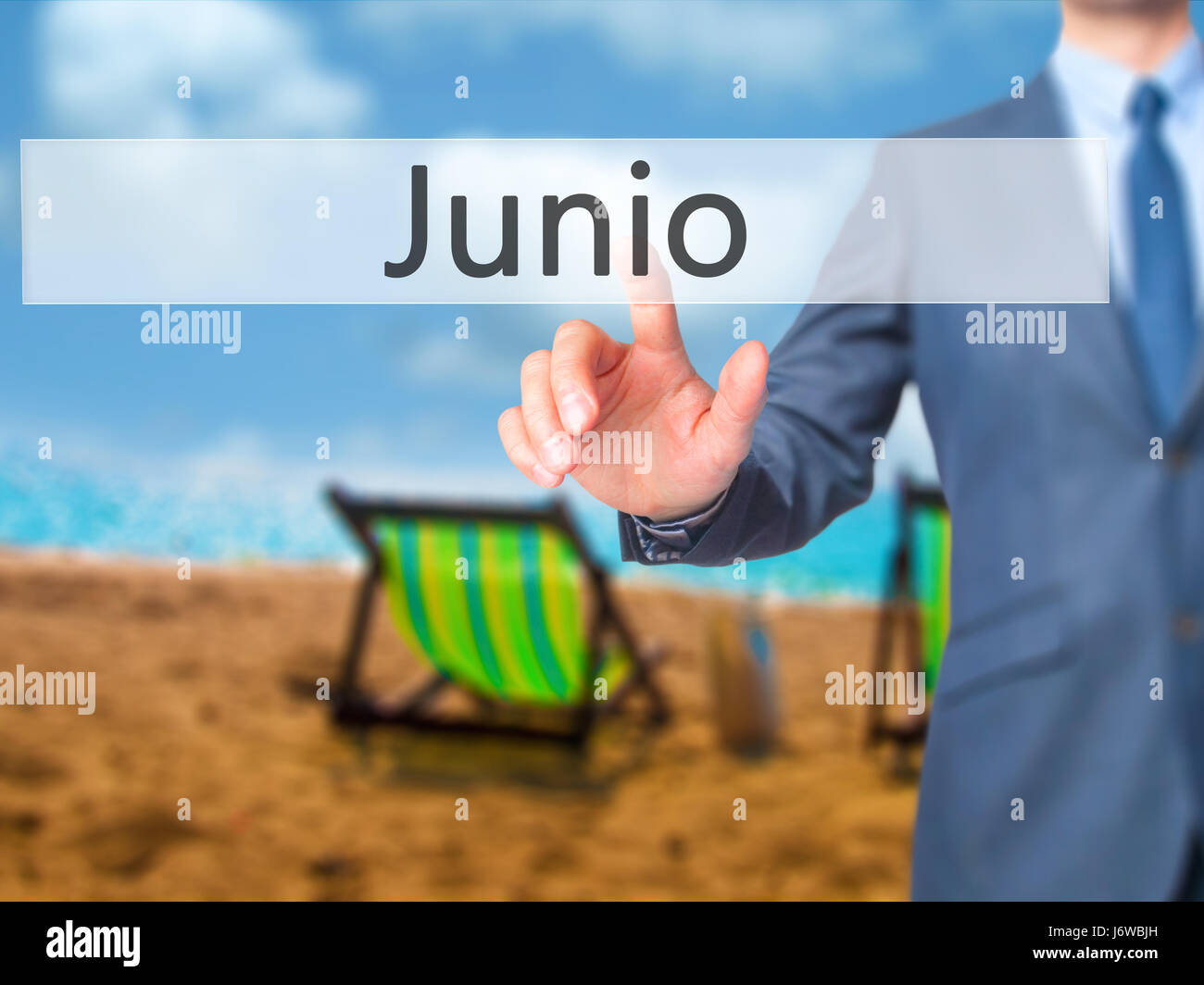 Junio (June in Spanish) - Businessman hand touch button on virtual ...
