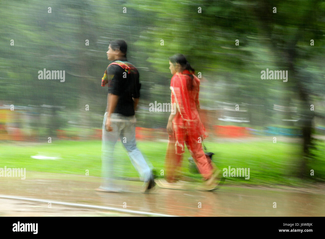 City dwellers enjoying the sudden rain at Suhrawardy Udyan in Dhaka ...