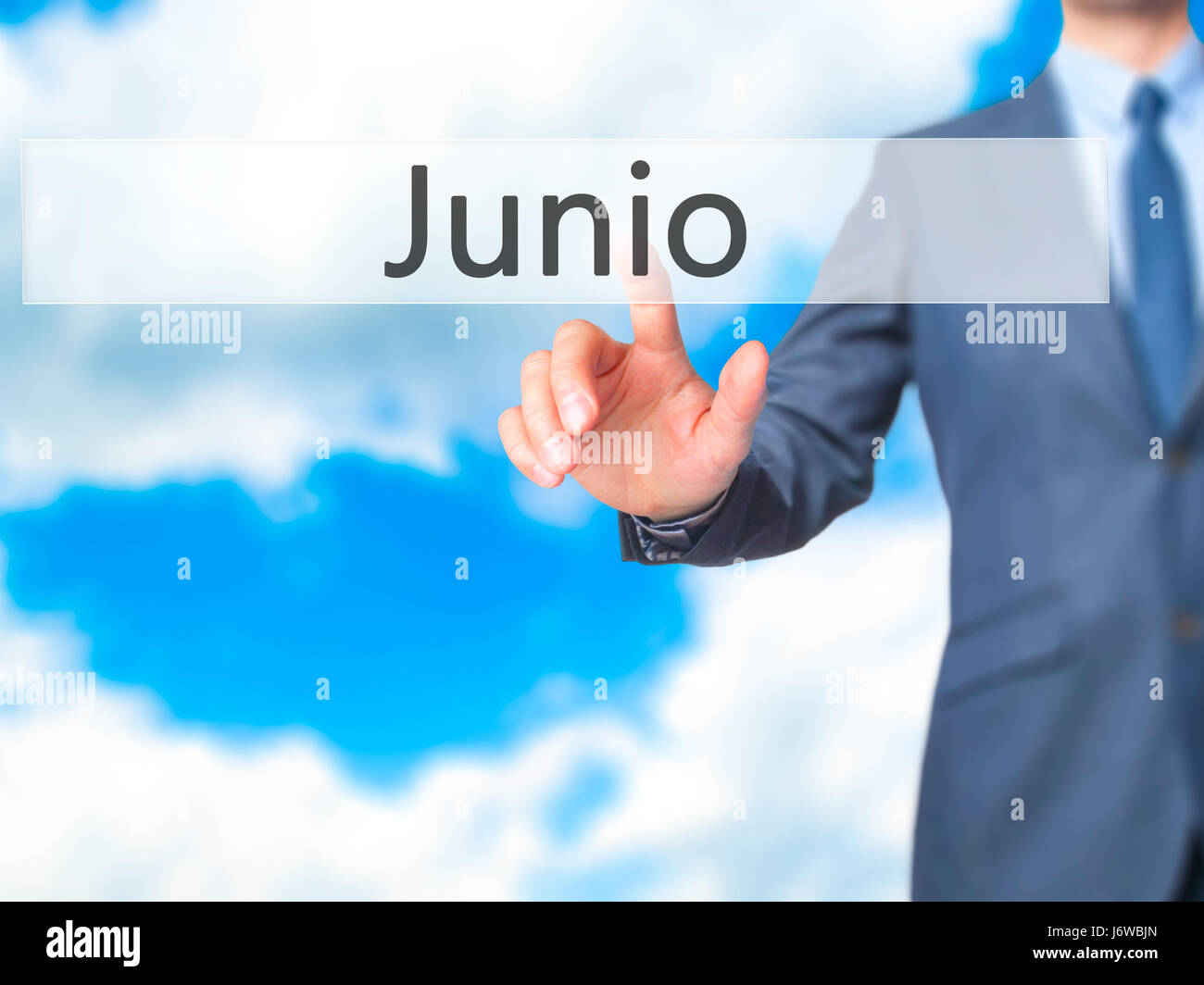 Junio (June in Spanish) - Businessman hand touch button on virtual ...