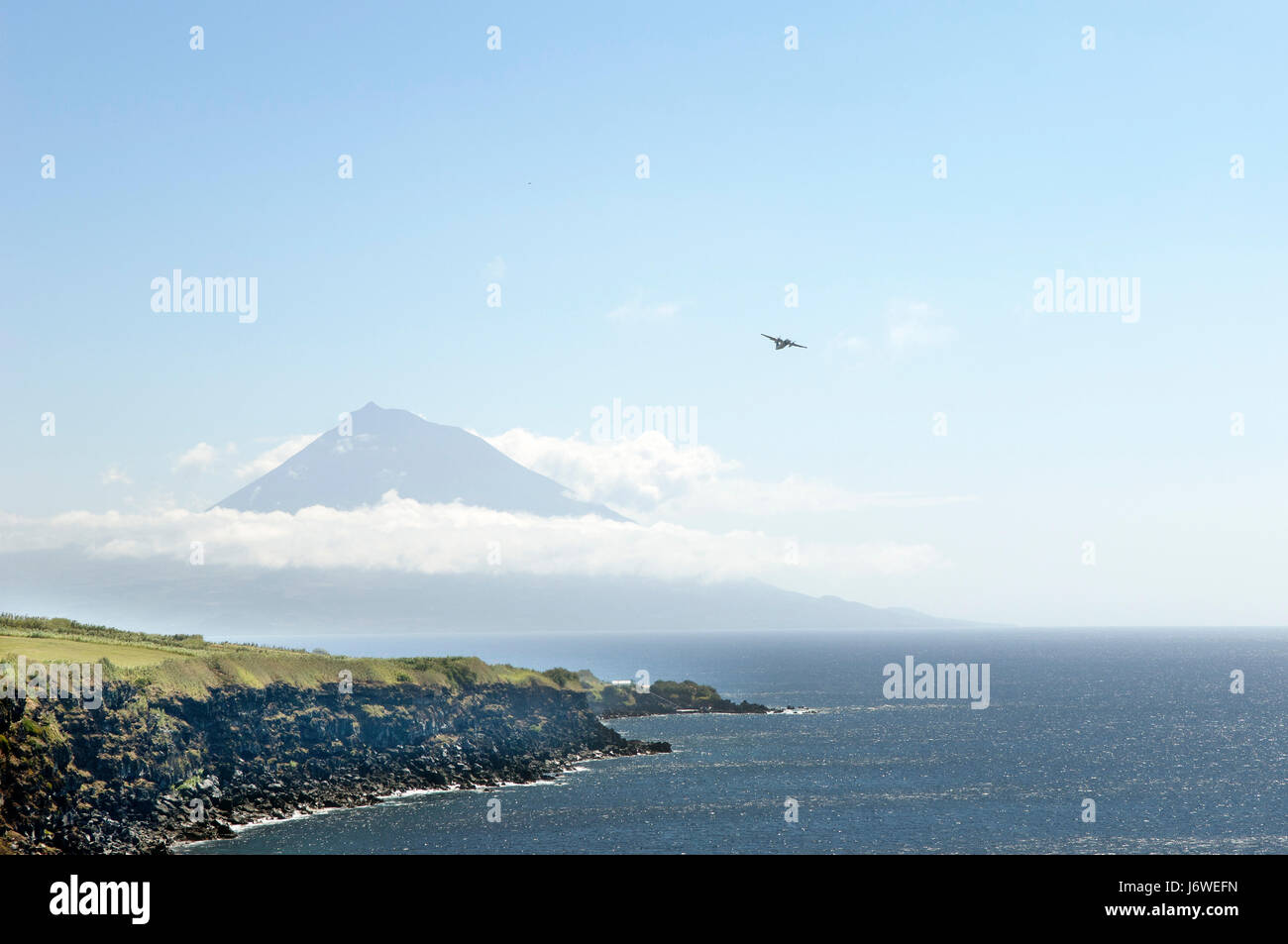 cliff azores volcanic salt water sea ocean water mountain fog haze rock ...