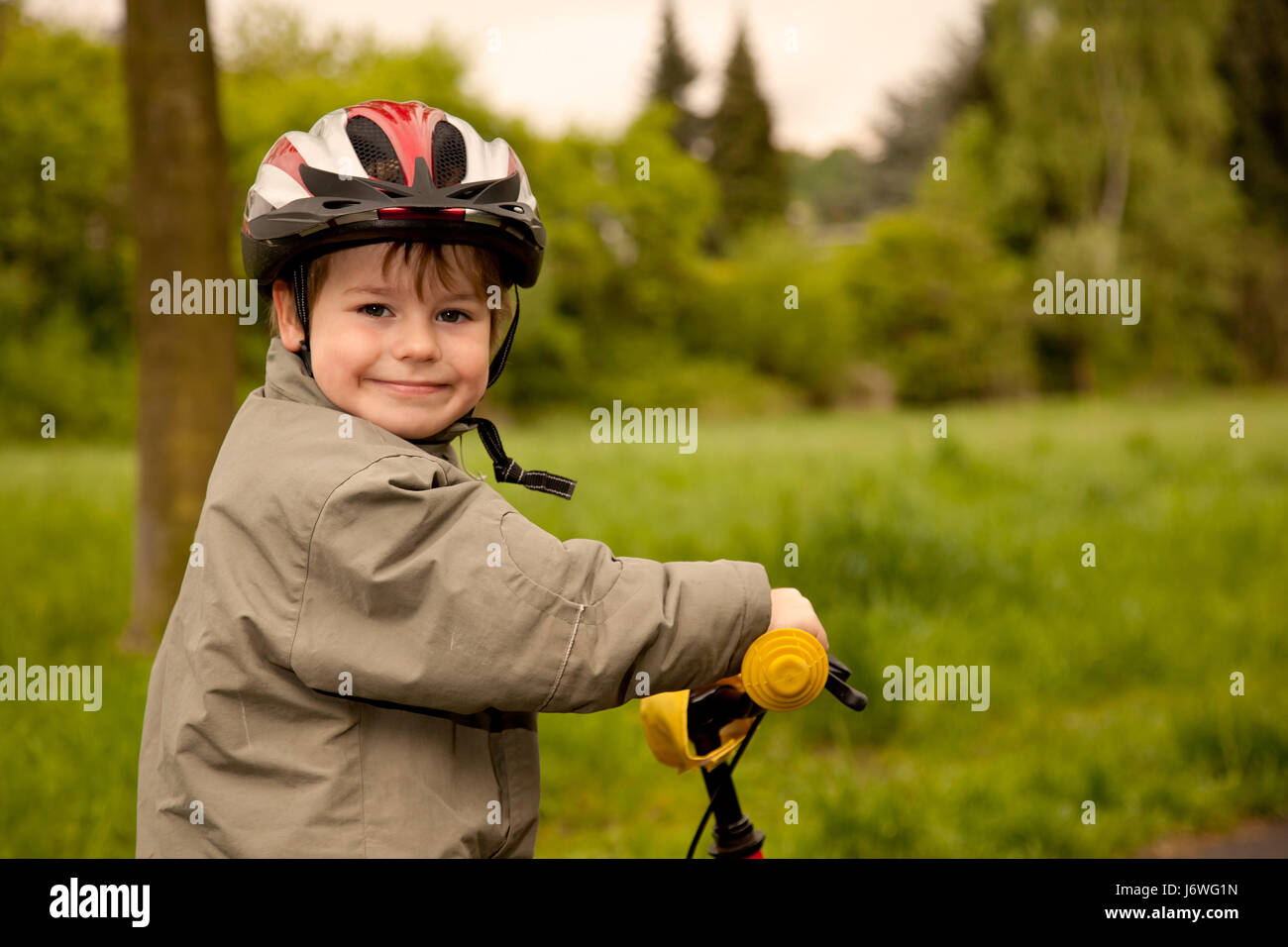 boy with helmet on bicycle Stock Photo - Alamy