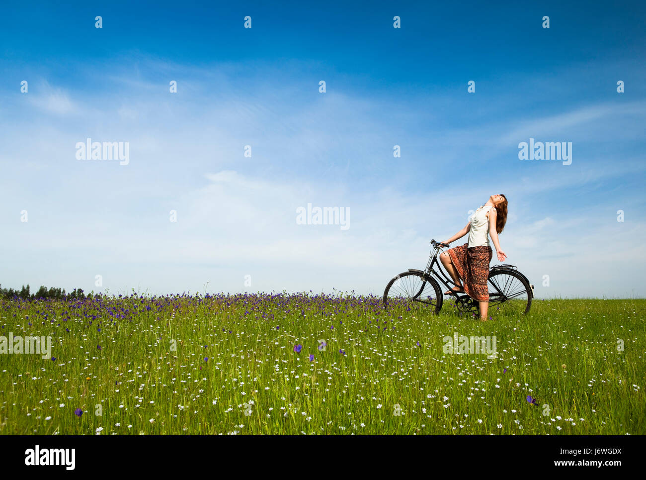 woman field spring bouncing bounces hop skipping frisks jumping jump ...