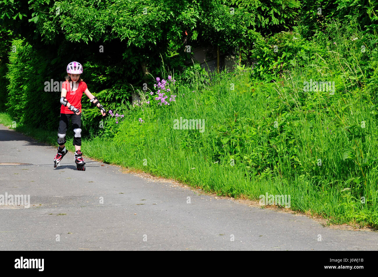 inline skating child girls summer Stock Photo - Alamy