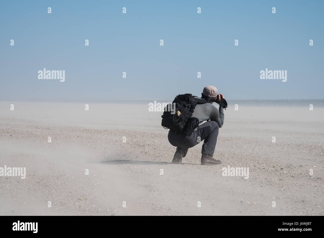 Man taking photos during windy day on the beach Stock Photo - Alamy