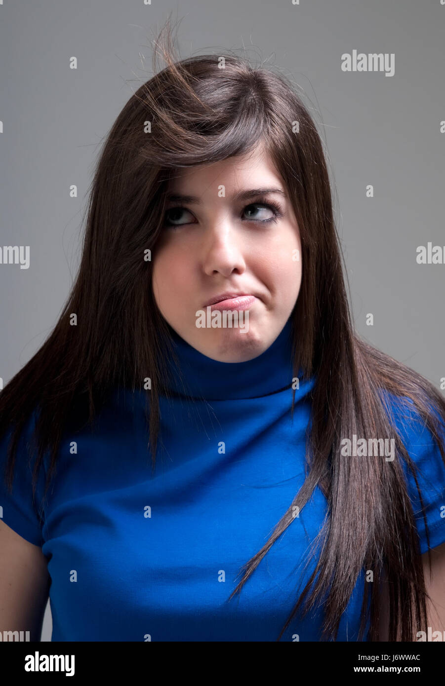 female face expression bored stress young younger hair woman beautiful ...