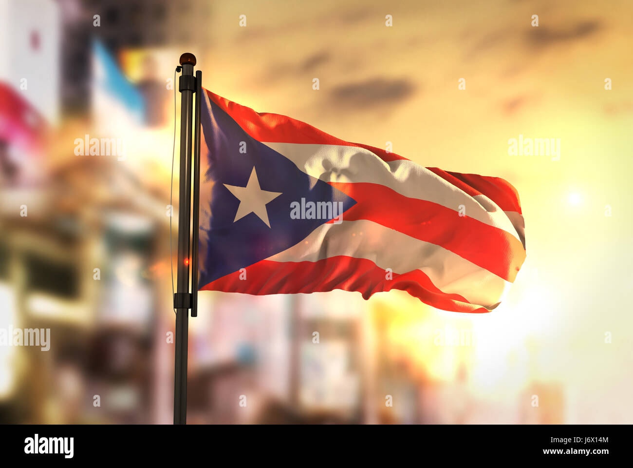Puerto Rico Flag Against City Blurred Background At Sunrise Backlight ...