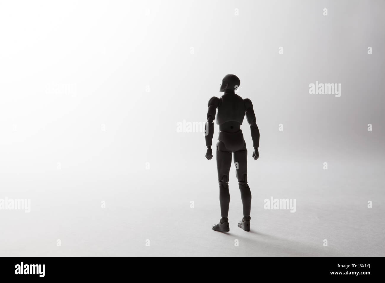 Male figurine silhouette standing in powerful pose looking up on white ...
