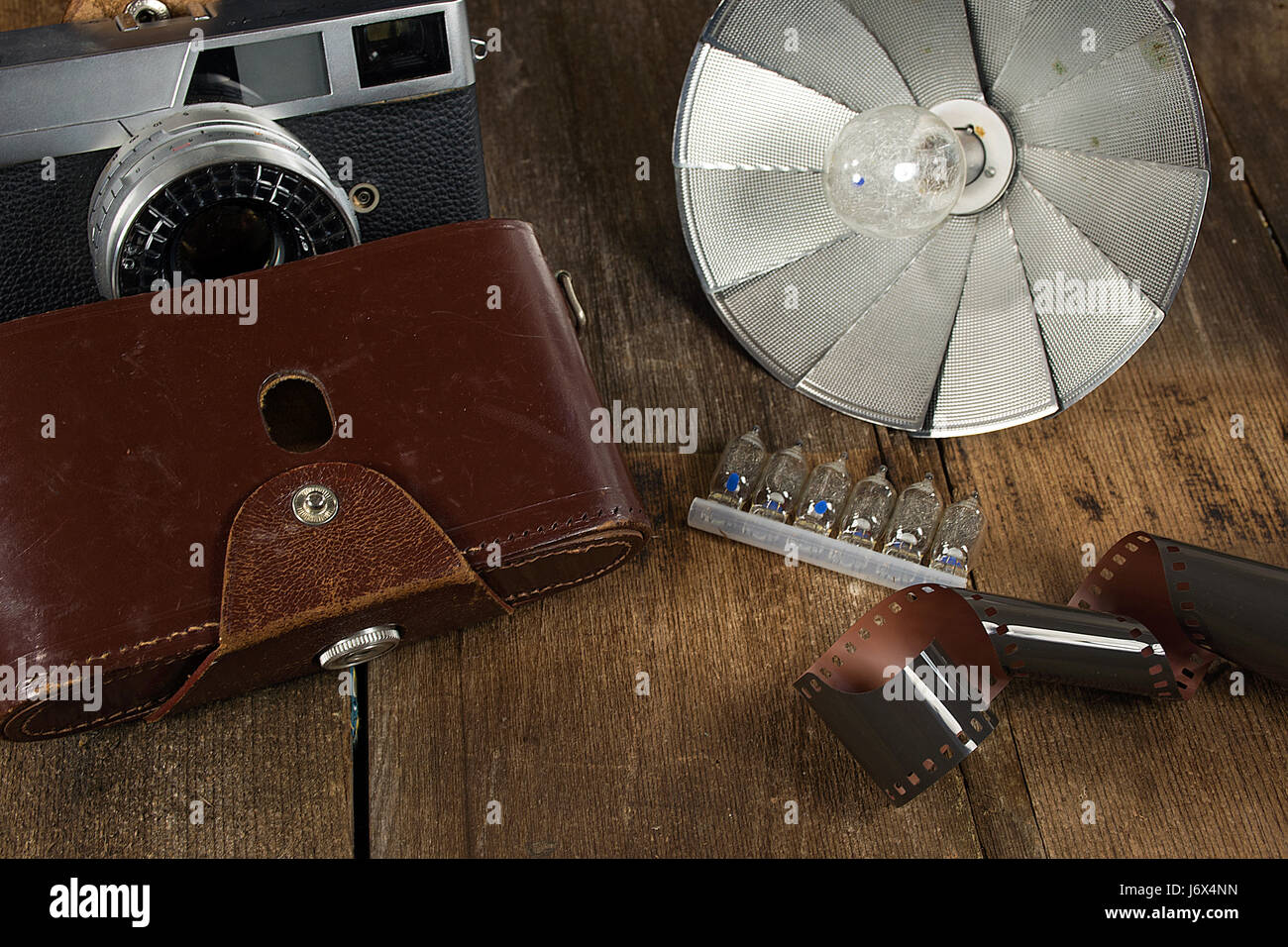 old camera with flash bulbs and roll of film on rustic wood Stock Photo ...