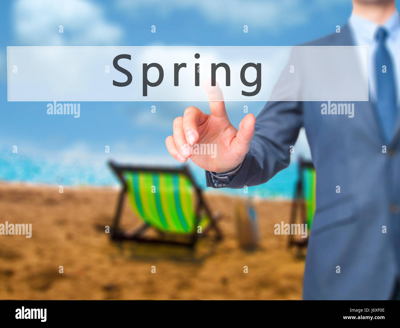 Spring - Businessman hand pressing button on touch screen interface ...