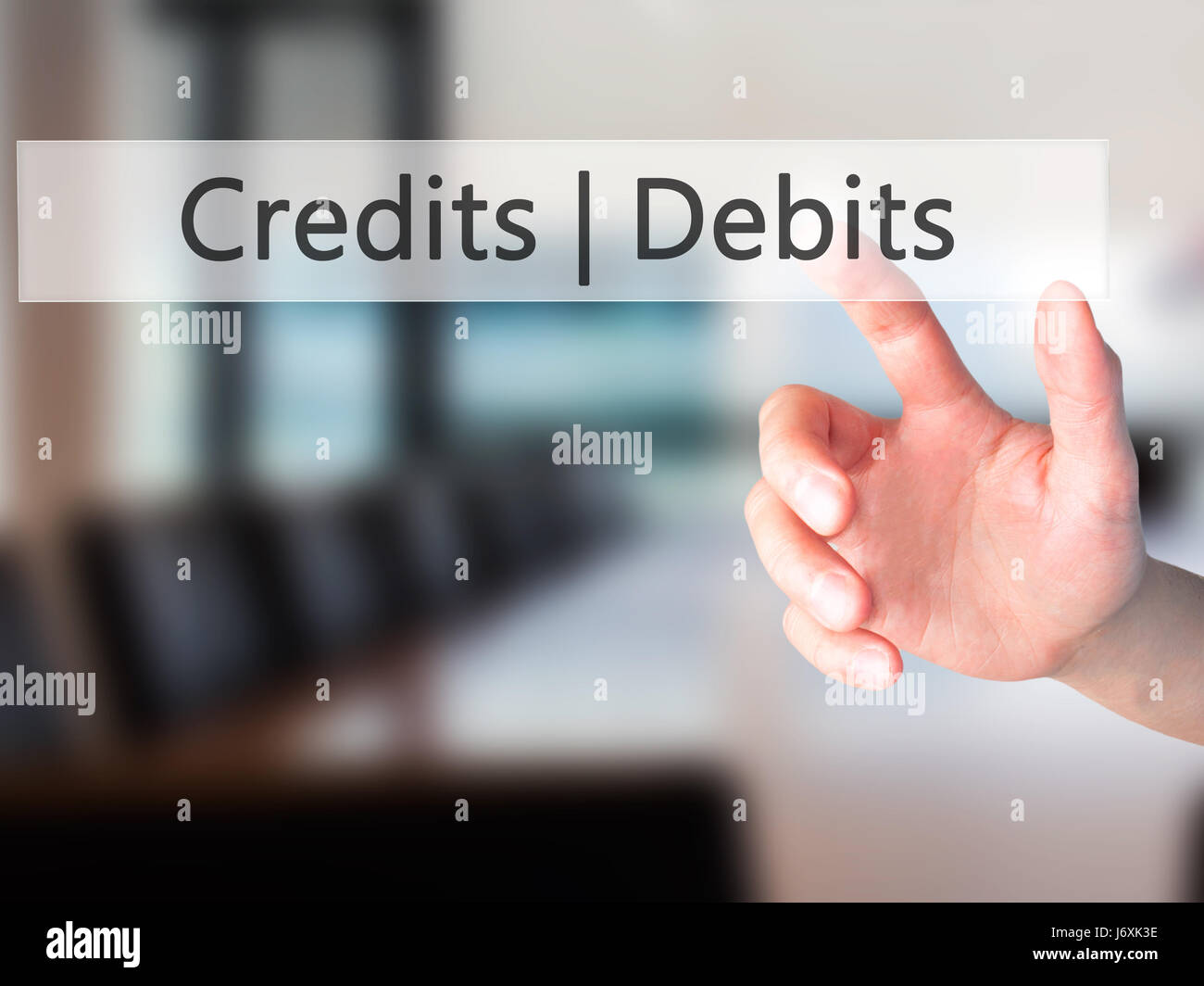 Credits Debits - Hand pressing a button on blurred background concept ...