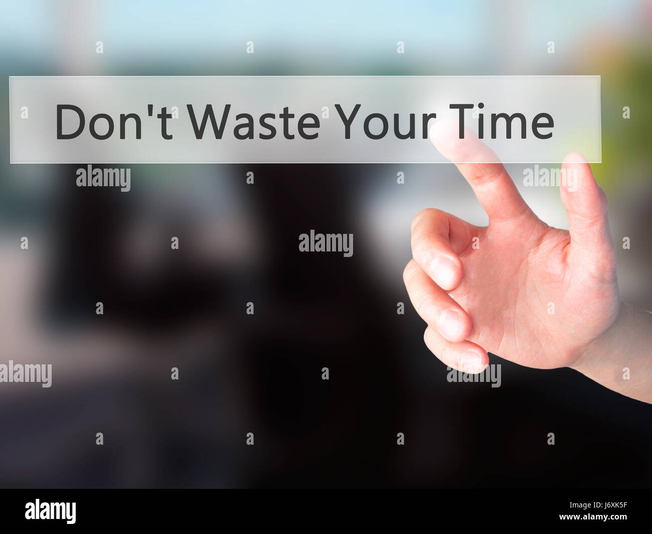 Don't Waste Your Time - Hand pressing a button on blurred background ...