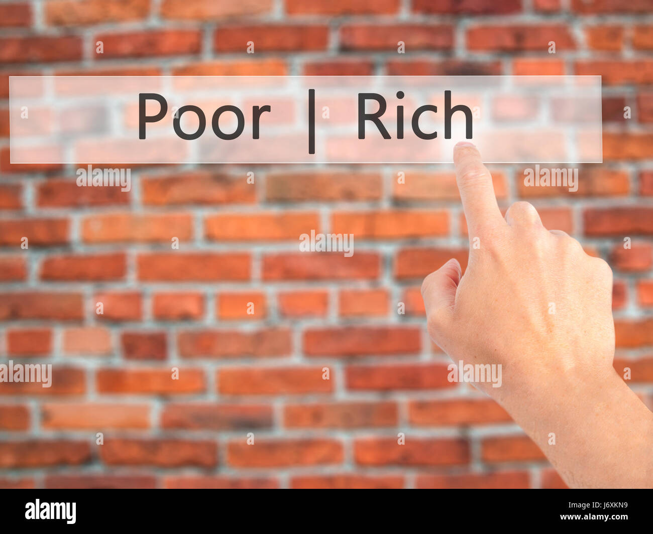 Poor Rich - Hand pressing a button on blurred background concept ...
