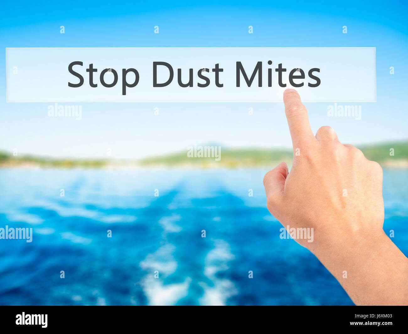 Stop Dust Mites - Hand pressing a button on blurred background concept ...