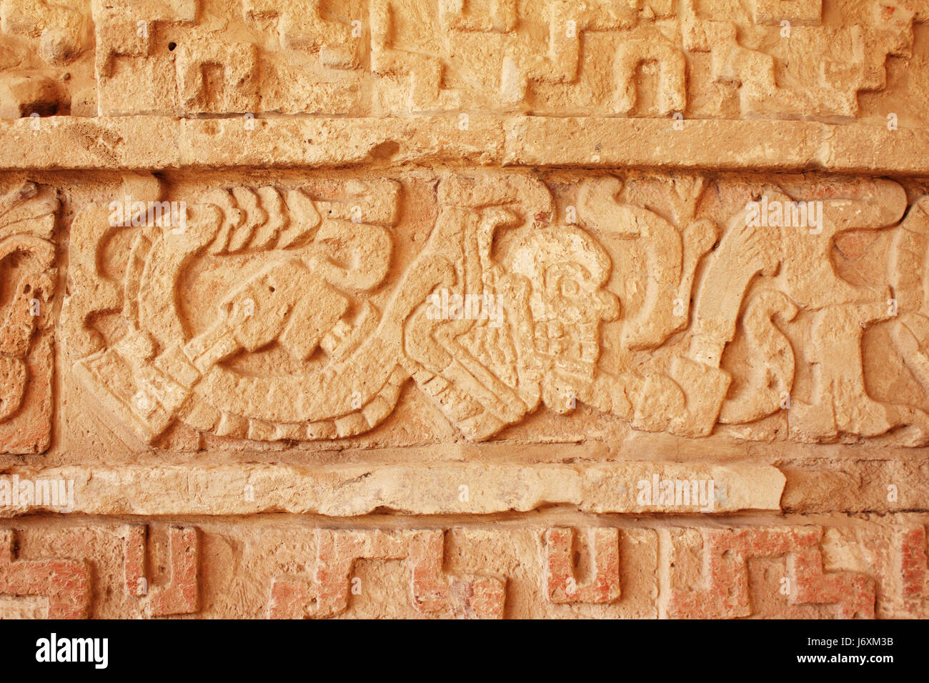 Grunge background with stucco texture and bas-relief carving of a snake ...