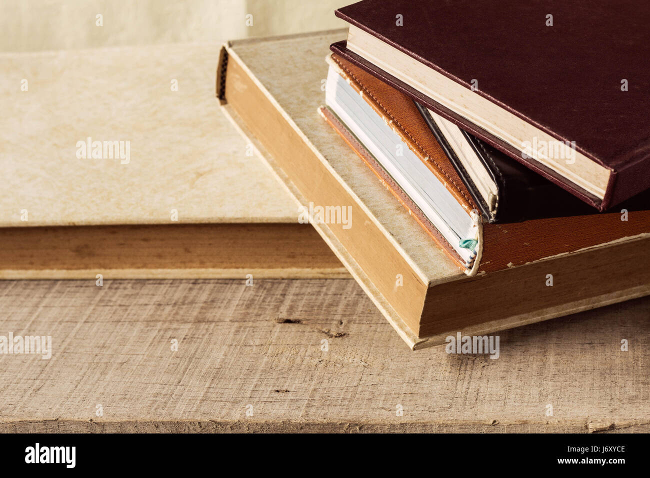 Old books put together on wooden floor Stock Photo - Alamy
