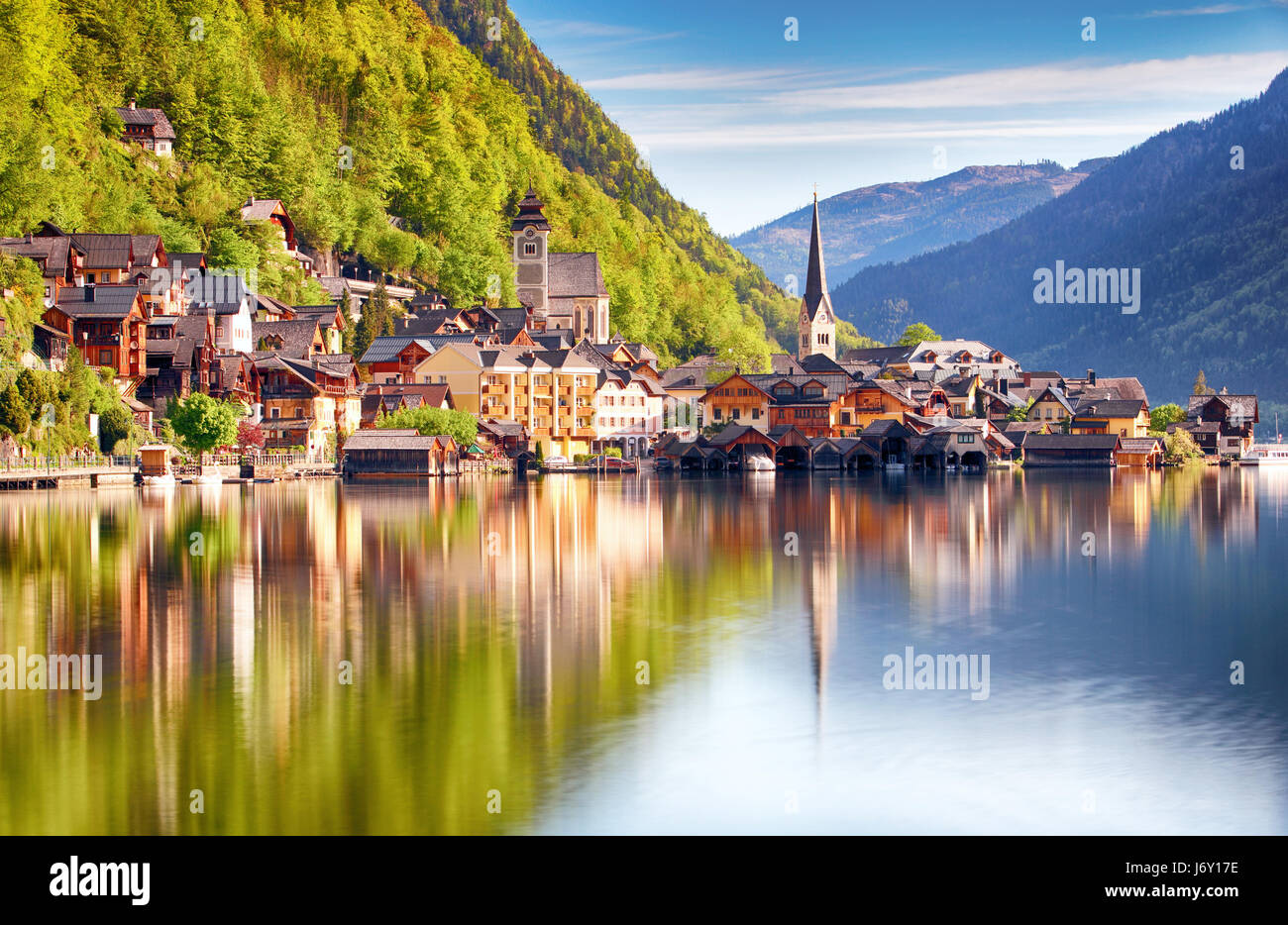 Classic postcard view of famous Hallstatt lakeside town reflecting in ...