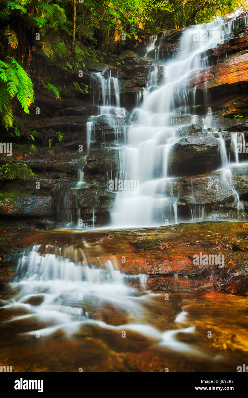 Frontal view of mighty natural Somersby waterfall in rocky creek on ...