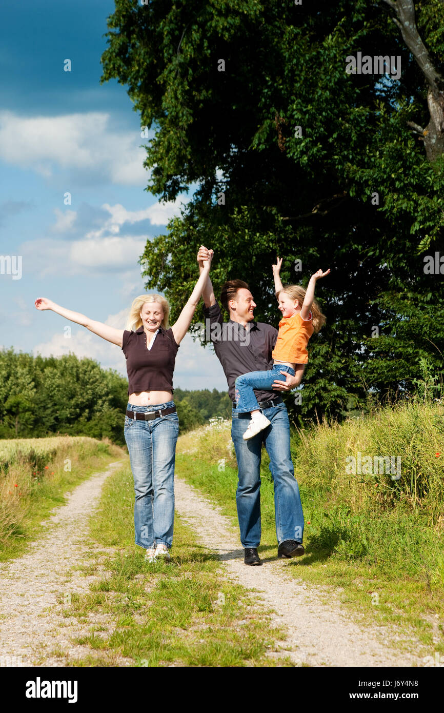family strolling in action Stock Photo - Alamy